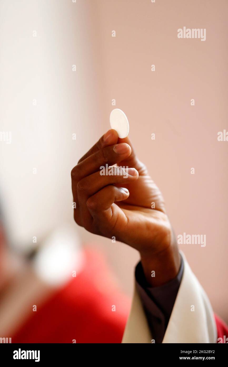 Sunday mass in a catholic parish. Priest giving Holy Communion ...