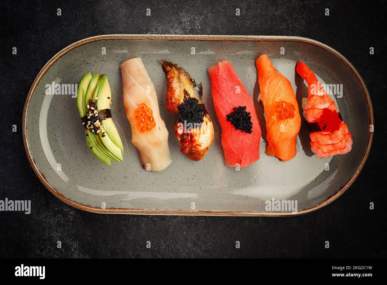 Assorted Nigiri sushi on a plate, on dark concrete. Top view Stock ...