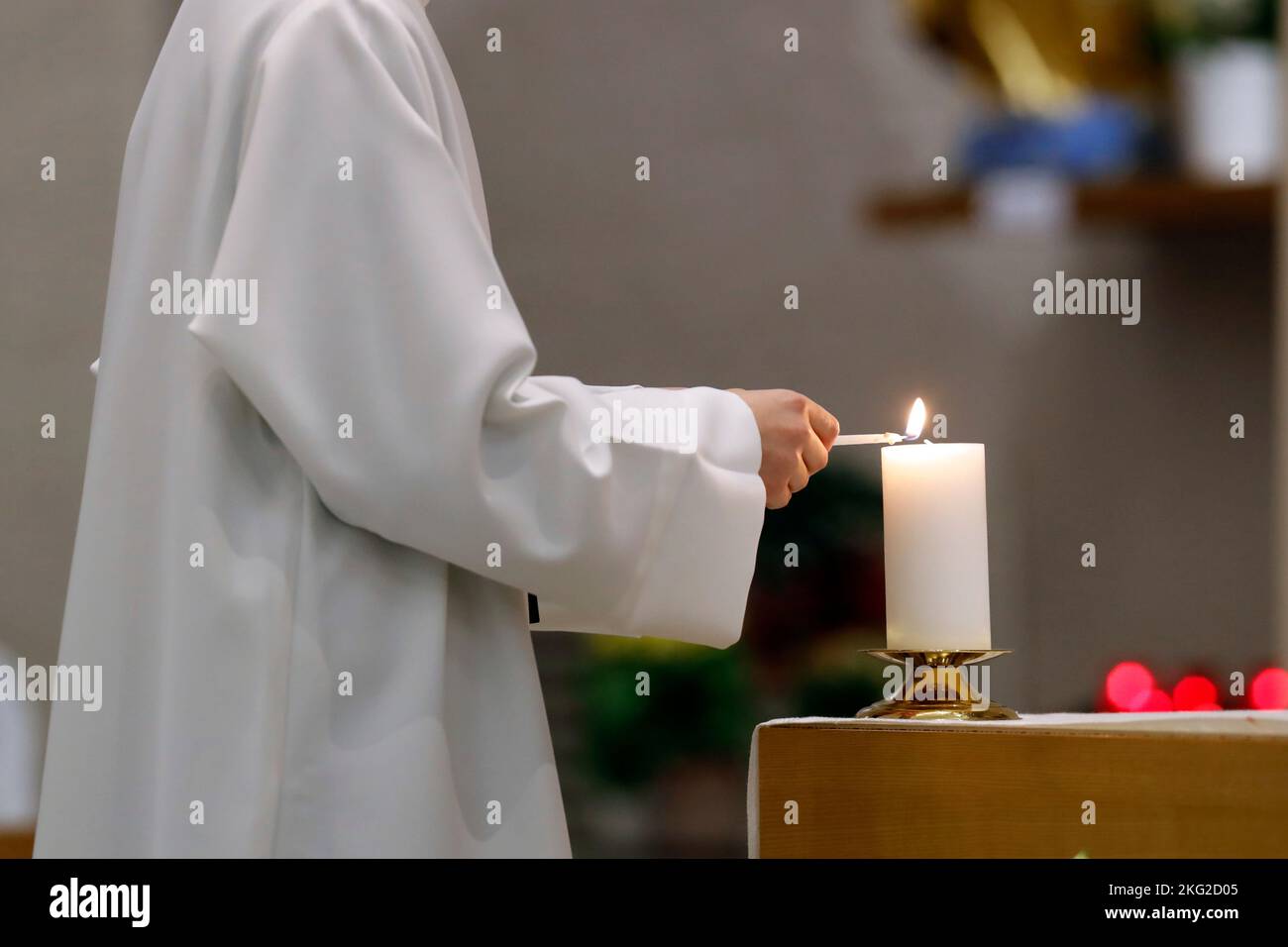 Altar boy with a church candel. Catholic mass. France Stock Photo - Alamy