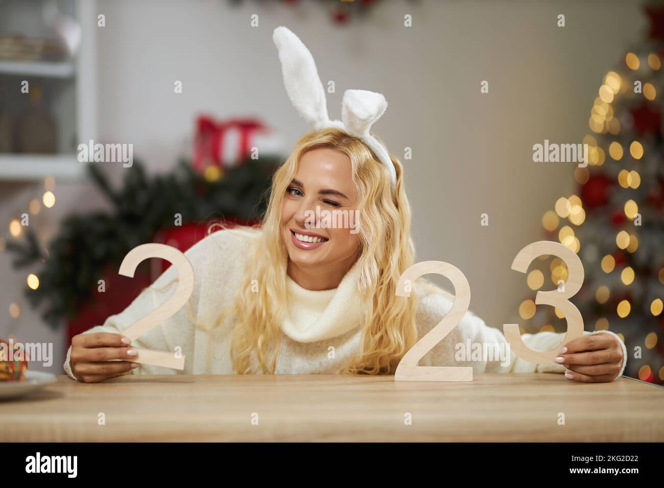 Front view of seductive, blonde female wearing rabbit ears, smiling ...