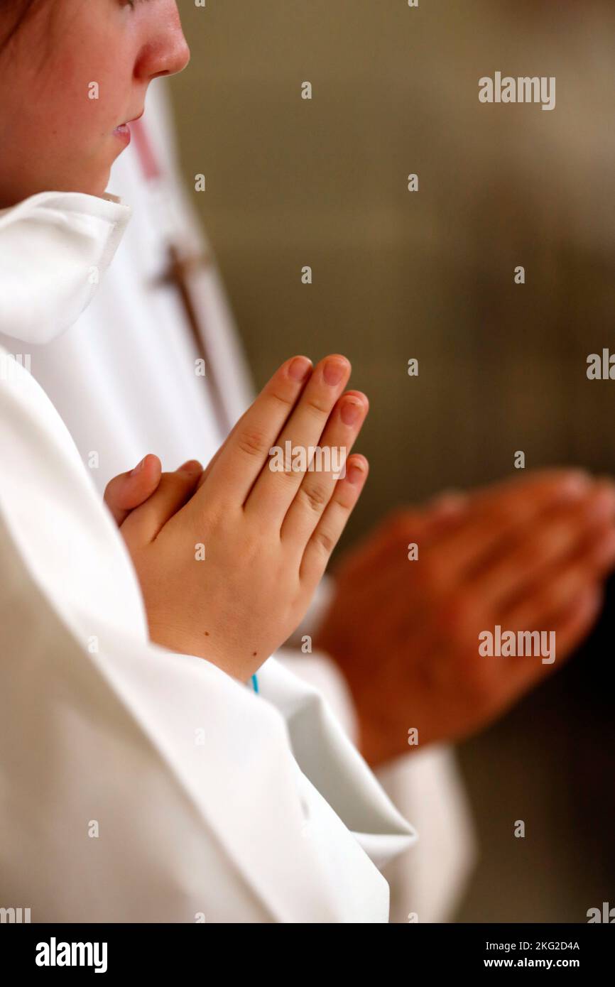 Catholic church. Altar boy praying at mass. France Stock Photo - Alamy