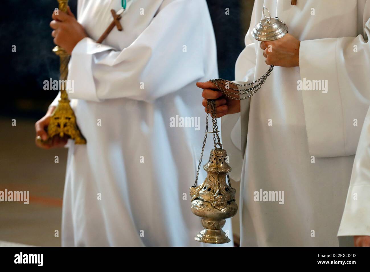 Catholic church. Altar boy shaking a censer to produce smoke and ...