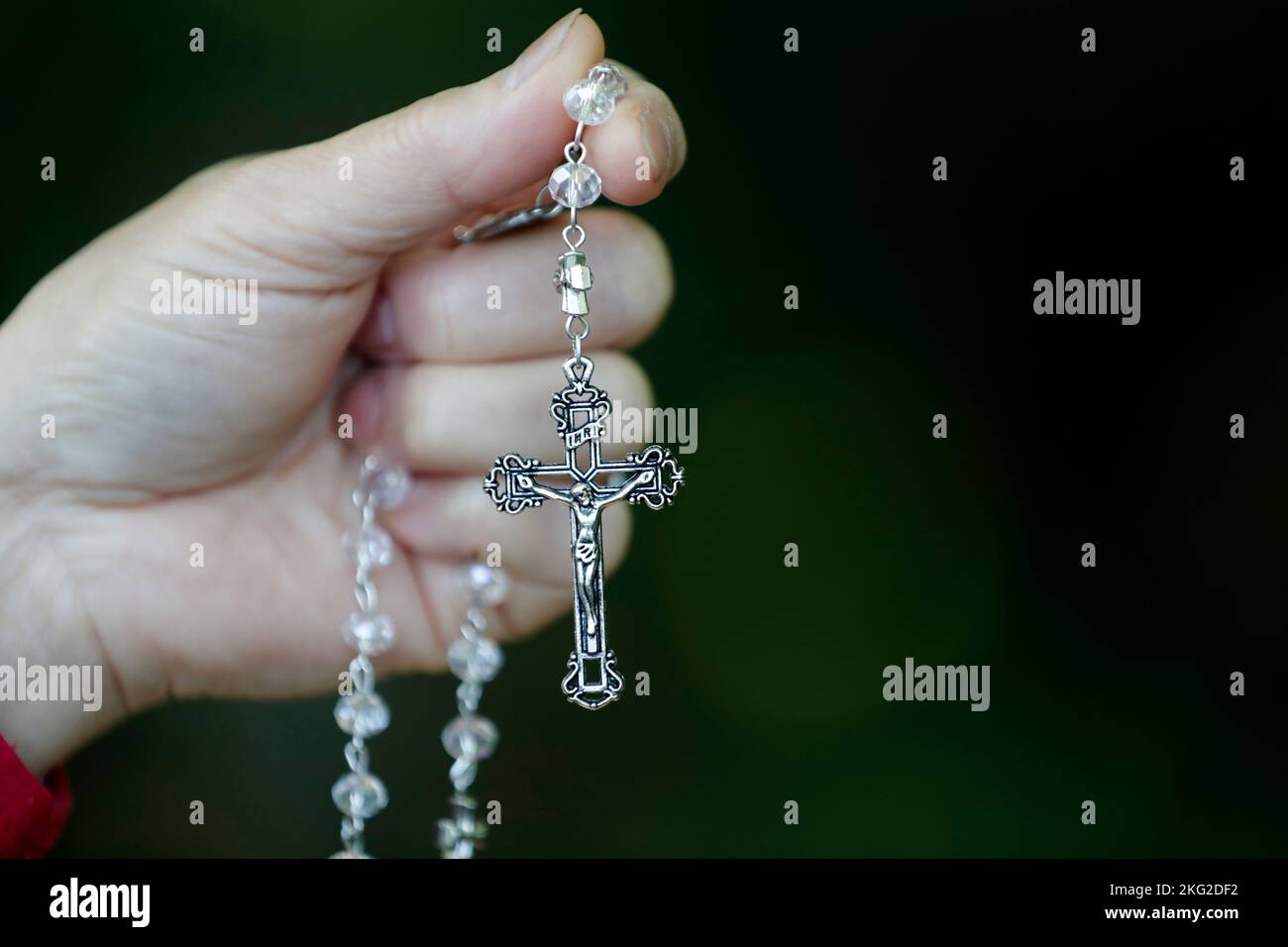Catholic woman praying the Rosary. Close up on hand Stock Photo - Alamy
