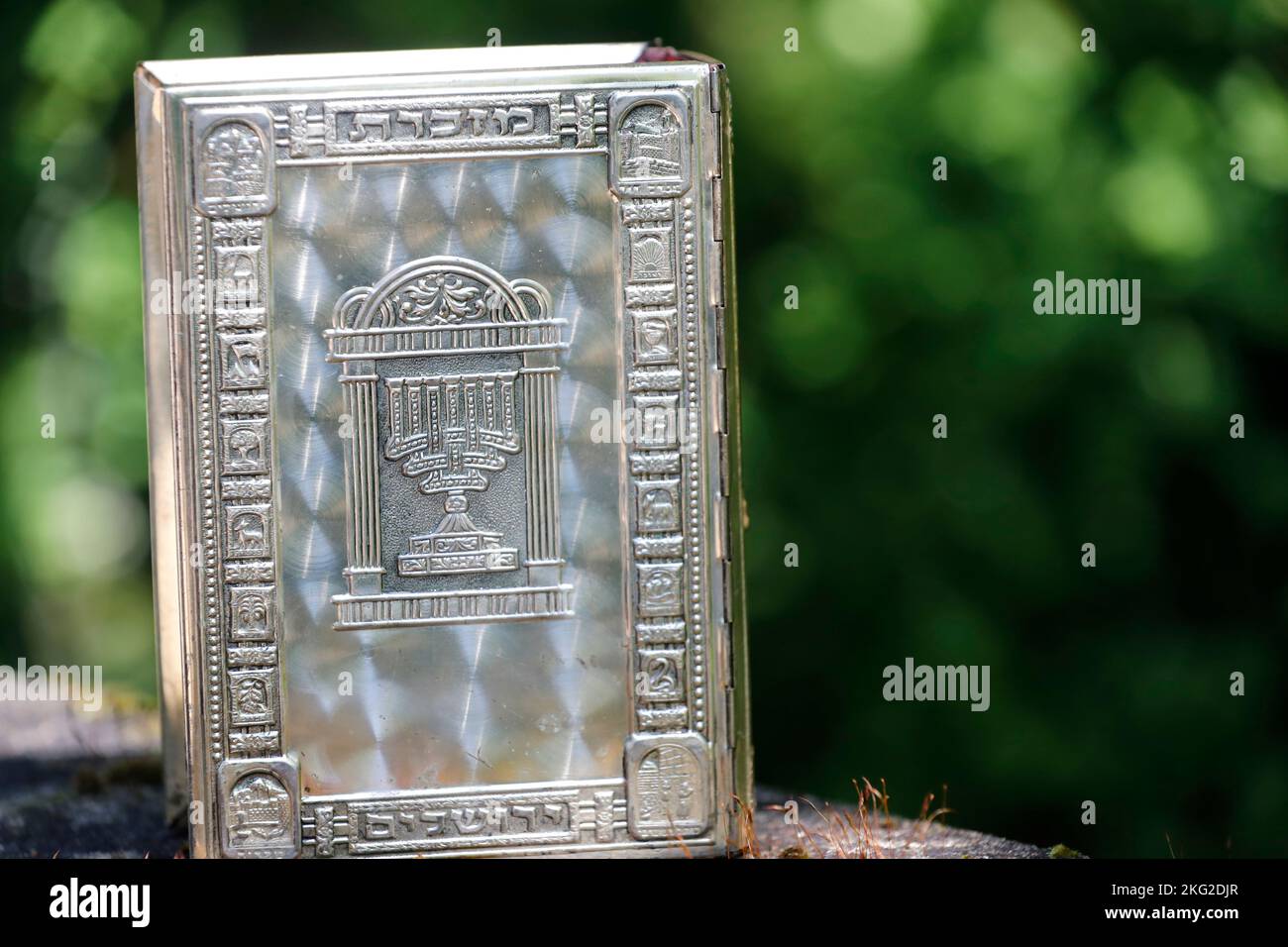 Old Torah book with the the five books of Moses. Cover with a menorah ...