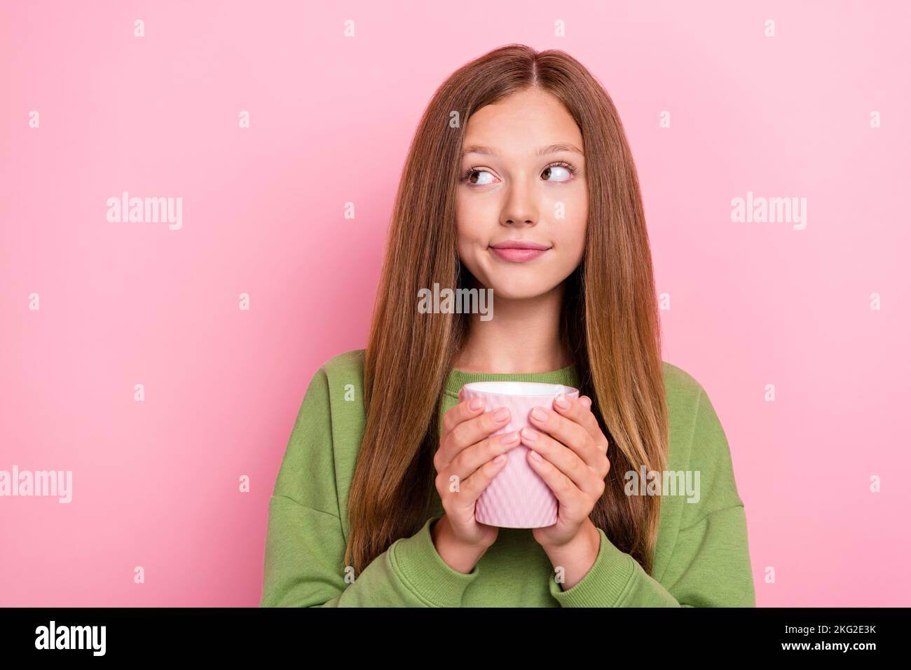 Photo of cute dreamy schoolgirl wear green sweatshirt drinking tea ...