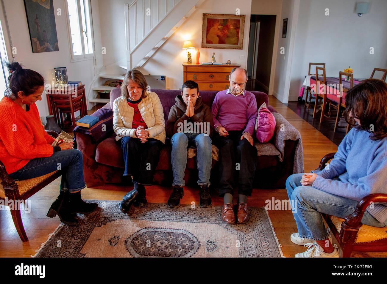 Family praying at home in Montrouge, France Stock Photo - Alamy