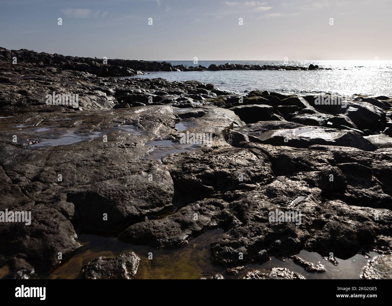 Rocky coastal terrain with blue sky Stock Photo - Alamy