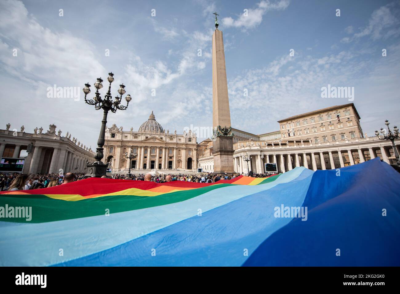 Children hold a rainbow flag as Pope Francis speaks to the crowd during ...