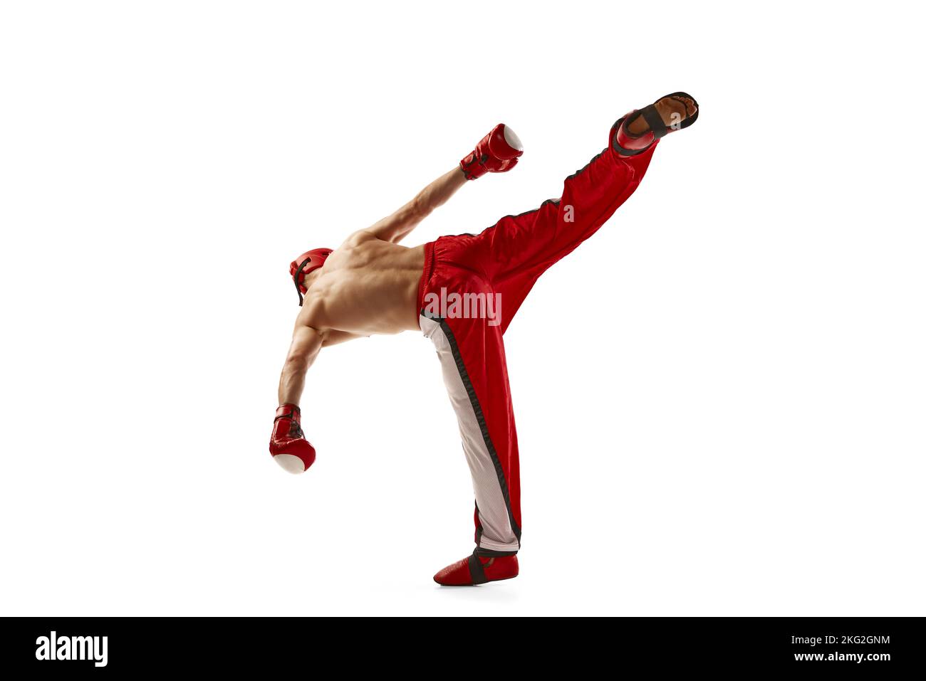 Young professional kickboxer wearing helmet and boxing gloves in motion ...