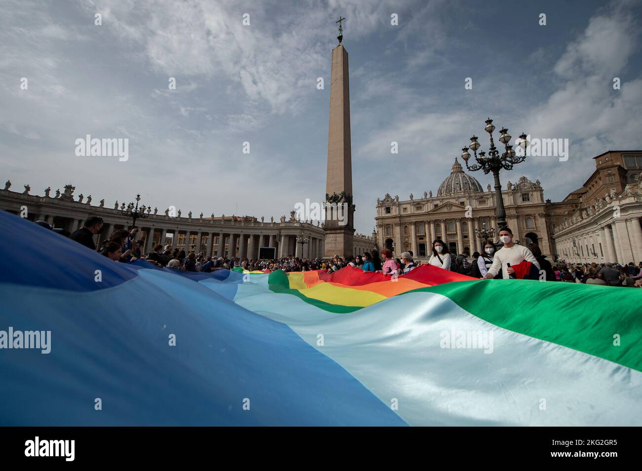 Children hold a rainbow flag as Pope Francis speaks to the crowd during ...