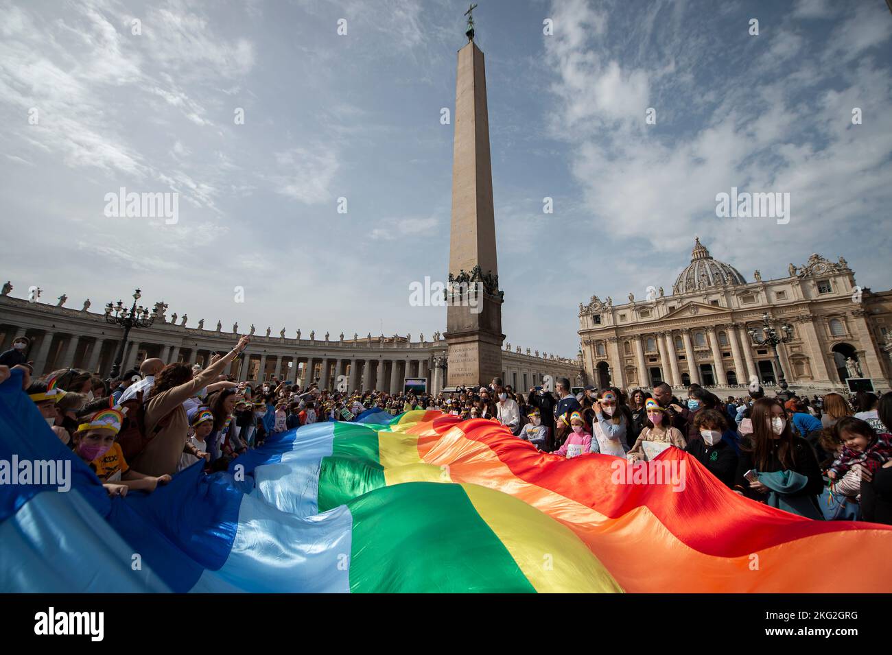 Children hold a rainbow flag as Pope Francis speaks to the crowd during ...