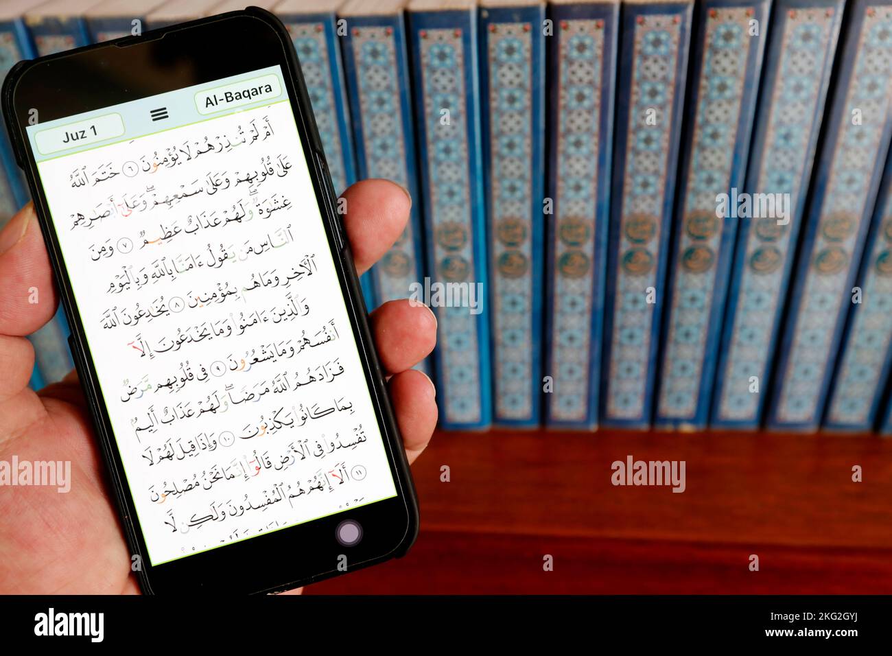 Al-Serkal Mosque. Digital Quran on a smartphone and traditional paper ...