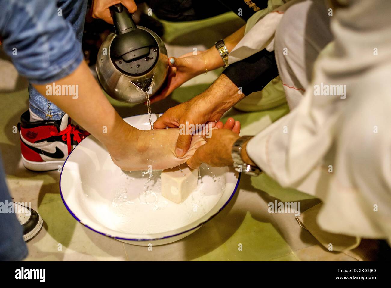 Priest washing feet of child hi-res stock photography and images - Alamy