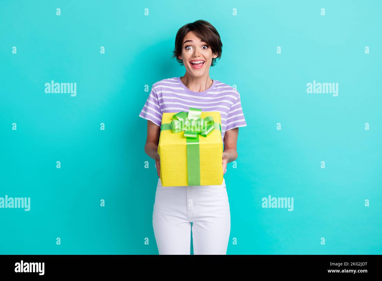Portrait of positive cheerful girl with bob hairstyle dressed striped t ...