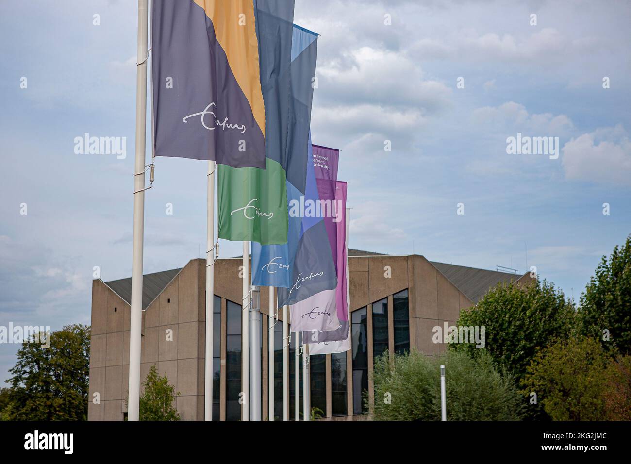 Waving flags in the wind with name logo of Erasmus University in front ...