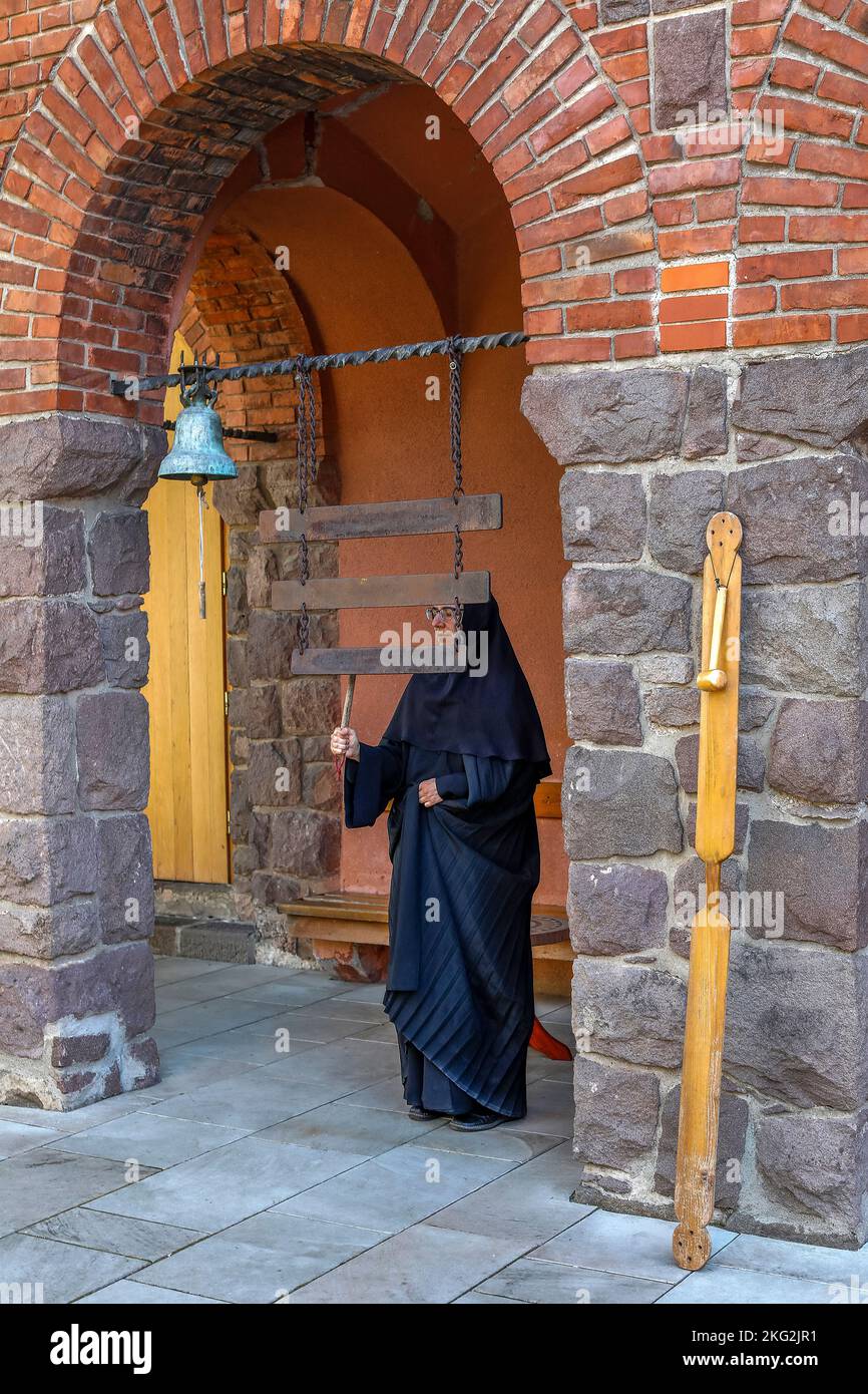 Zica orthodox monastery near Kraljevo, Serbia. Nun sounding the call to ...