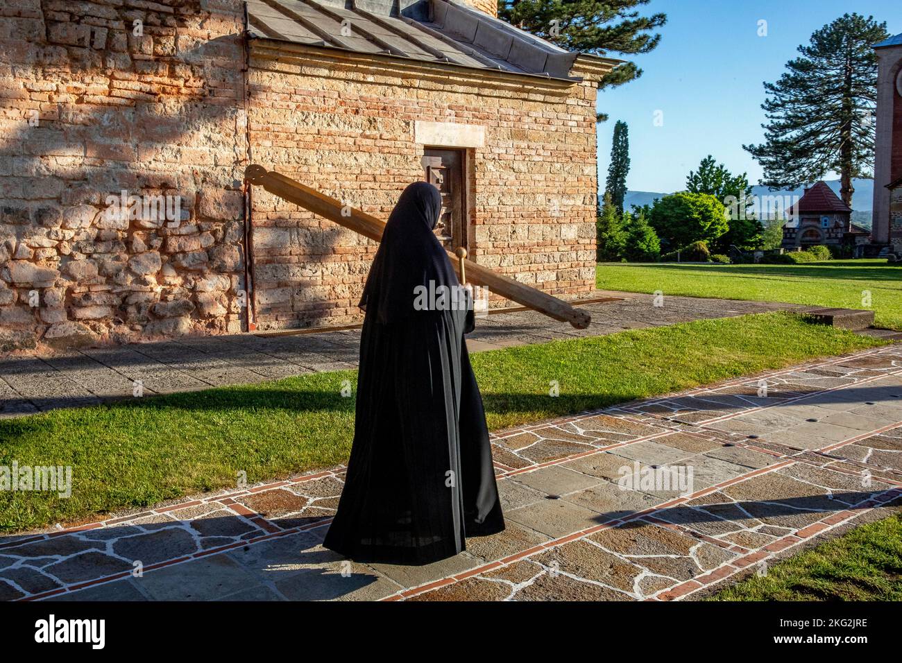 Zica orthodox monastery near Kraljevo, Serbia. Nun sounding the call to ...