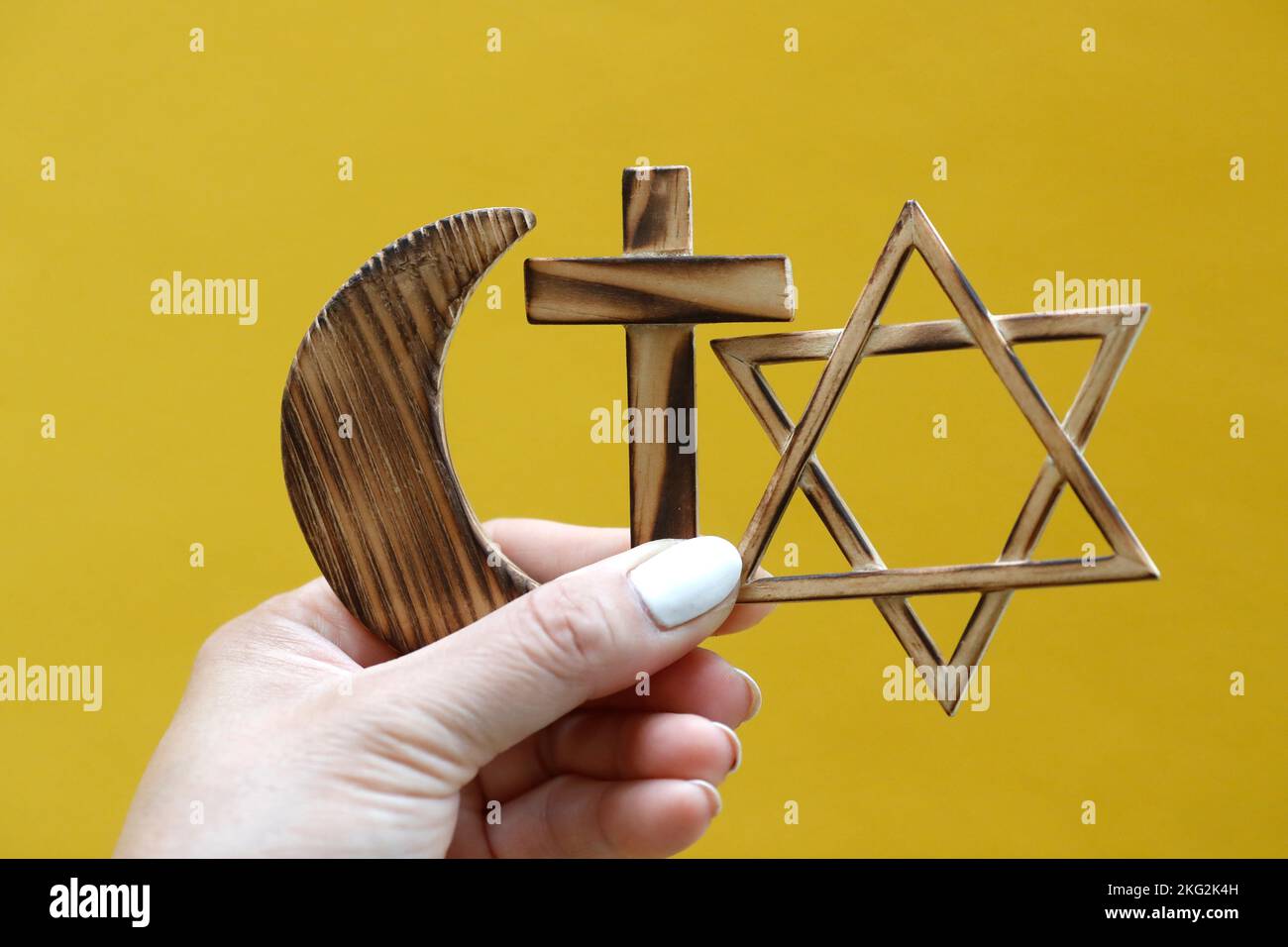 Religious symbols in hand. Jewish Star of David, Muslim star and ...