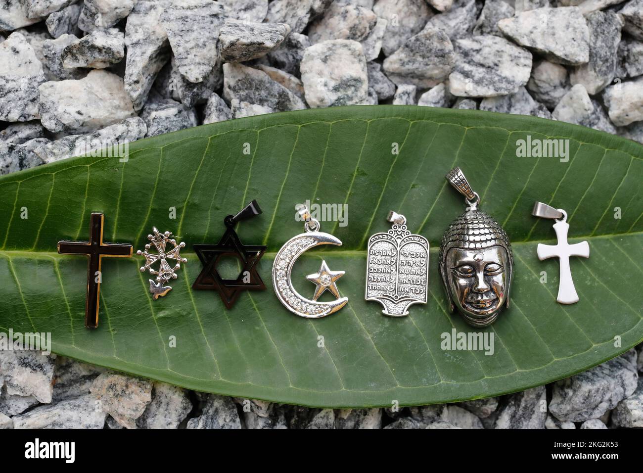 Religious symbols on a green leaf : Catholic, Islam, Judaism, Orthodox ...