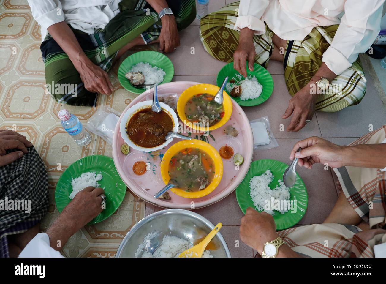 Muslim men sharing a free meal in mosque. Chau Doc. Vietnam Stock Photo ...