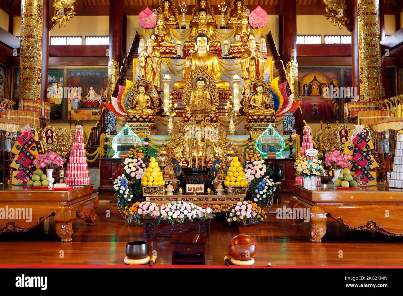 Ba Vang buddhist temple. Golden Buddha statues on main altar. Uong Bi ...