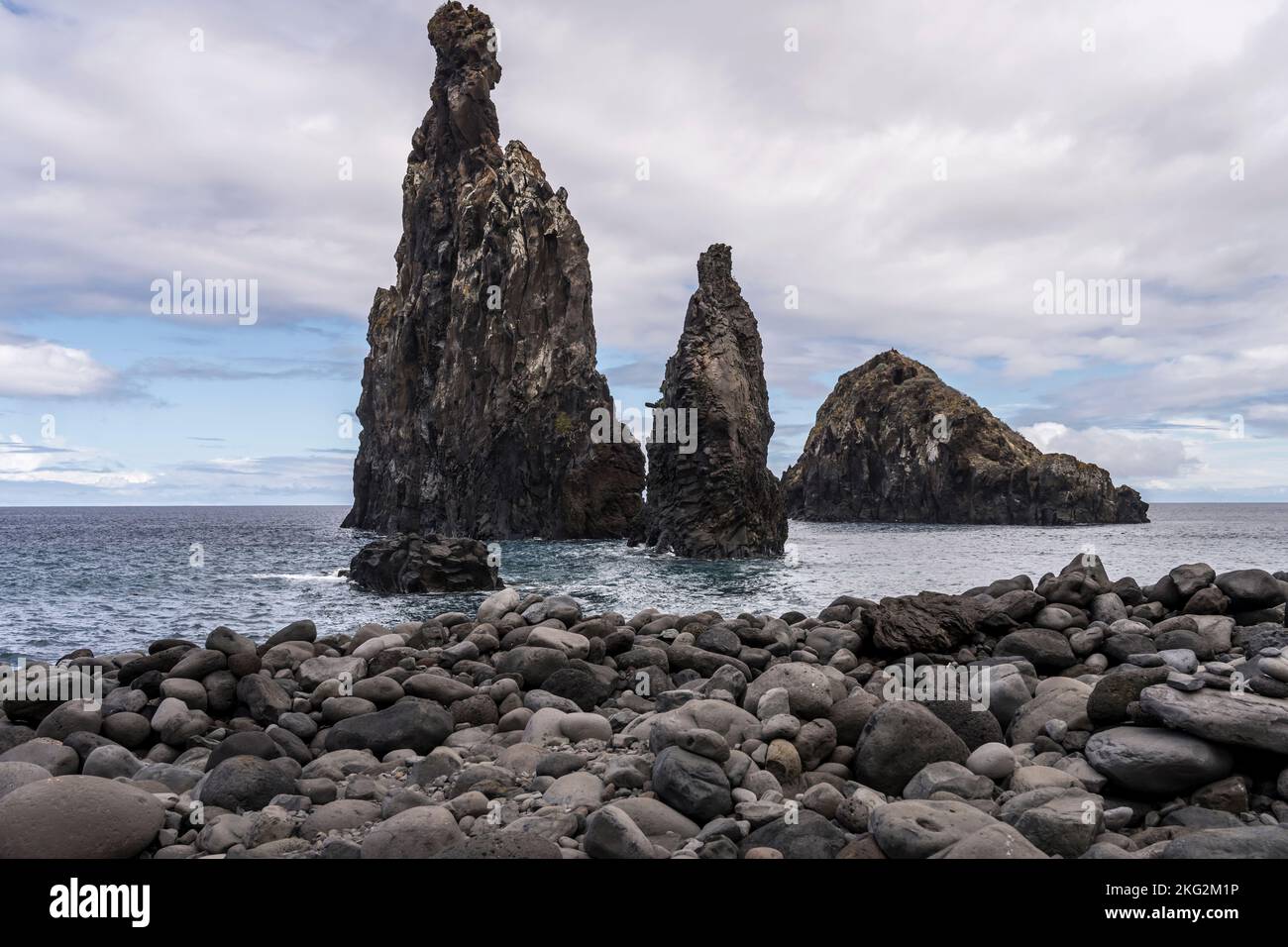 landscape of ocean shore at Madeira island with stony black beach and ...