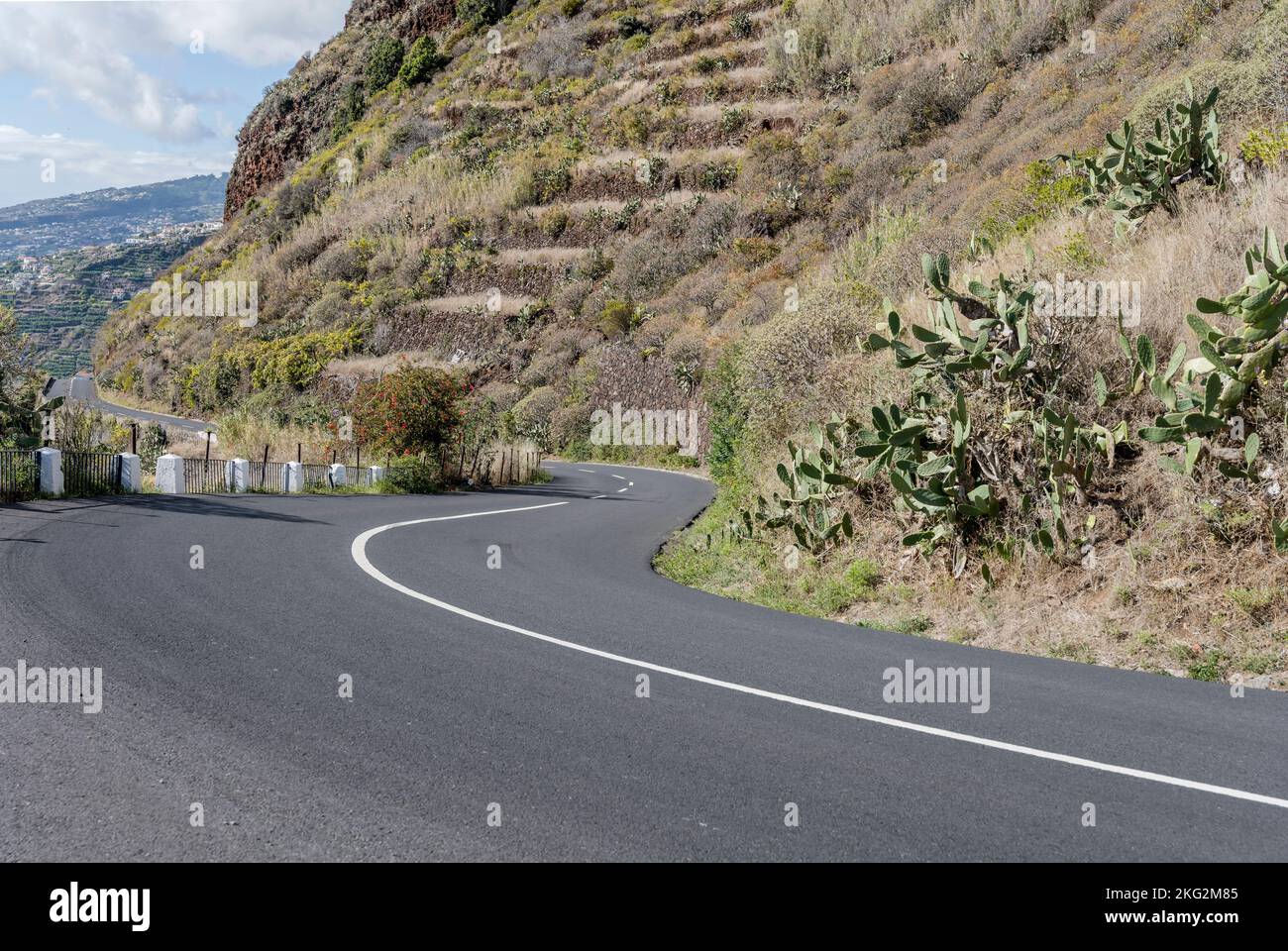 landscape with winding road on steep slopes of southern Atlantic shore ...