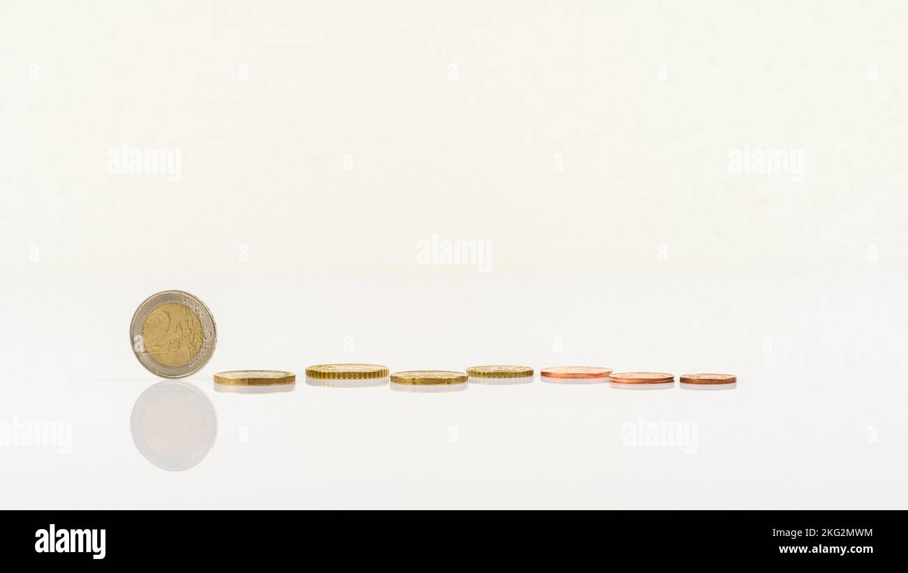 complete set of euro coins has fallen over on a white table - 2 euro ...