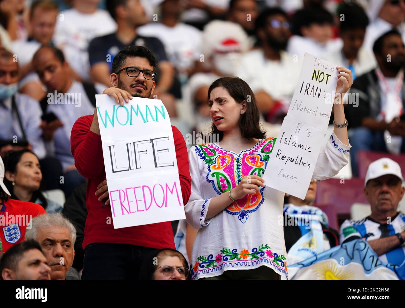 Iran fans in the stands hold up signs of protest ahead of the FIFA ...