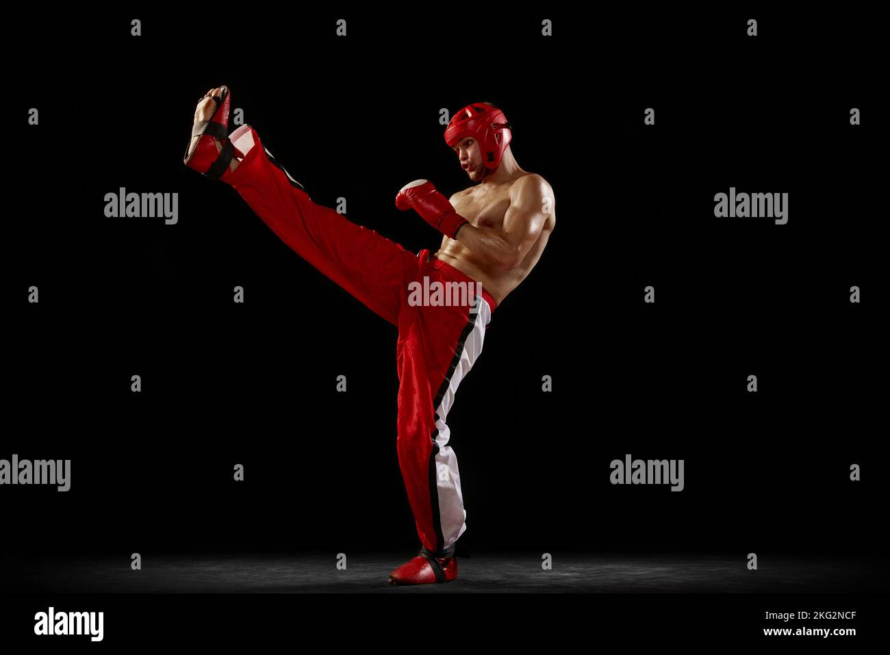 Studio shot of male kickboxer, mma fighter in motion and action ...