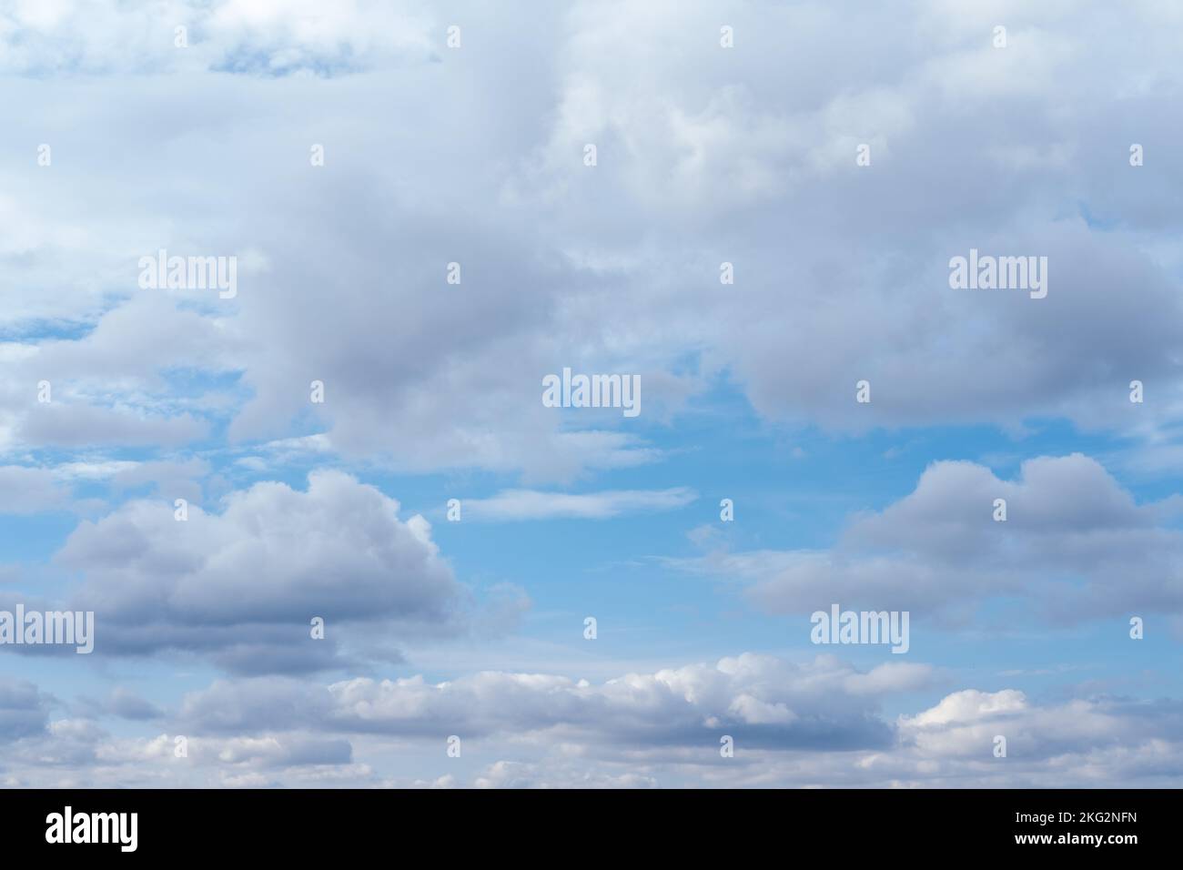 Lots of cumulus clouds far on horizon on blue daylight sky. Light blue ...