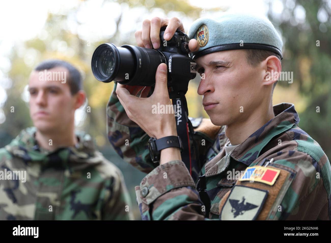 A Moldovan soldier practices capturing different angles during a ...