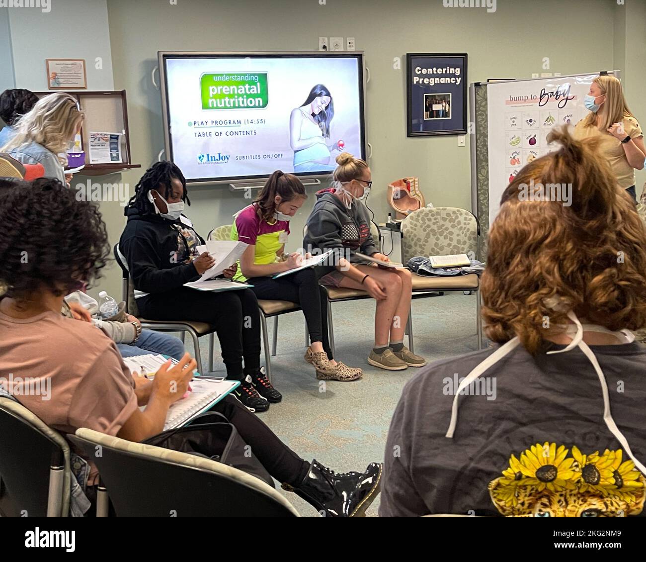 Centering Pregnancy participants complete paperwork before learning ...