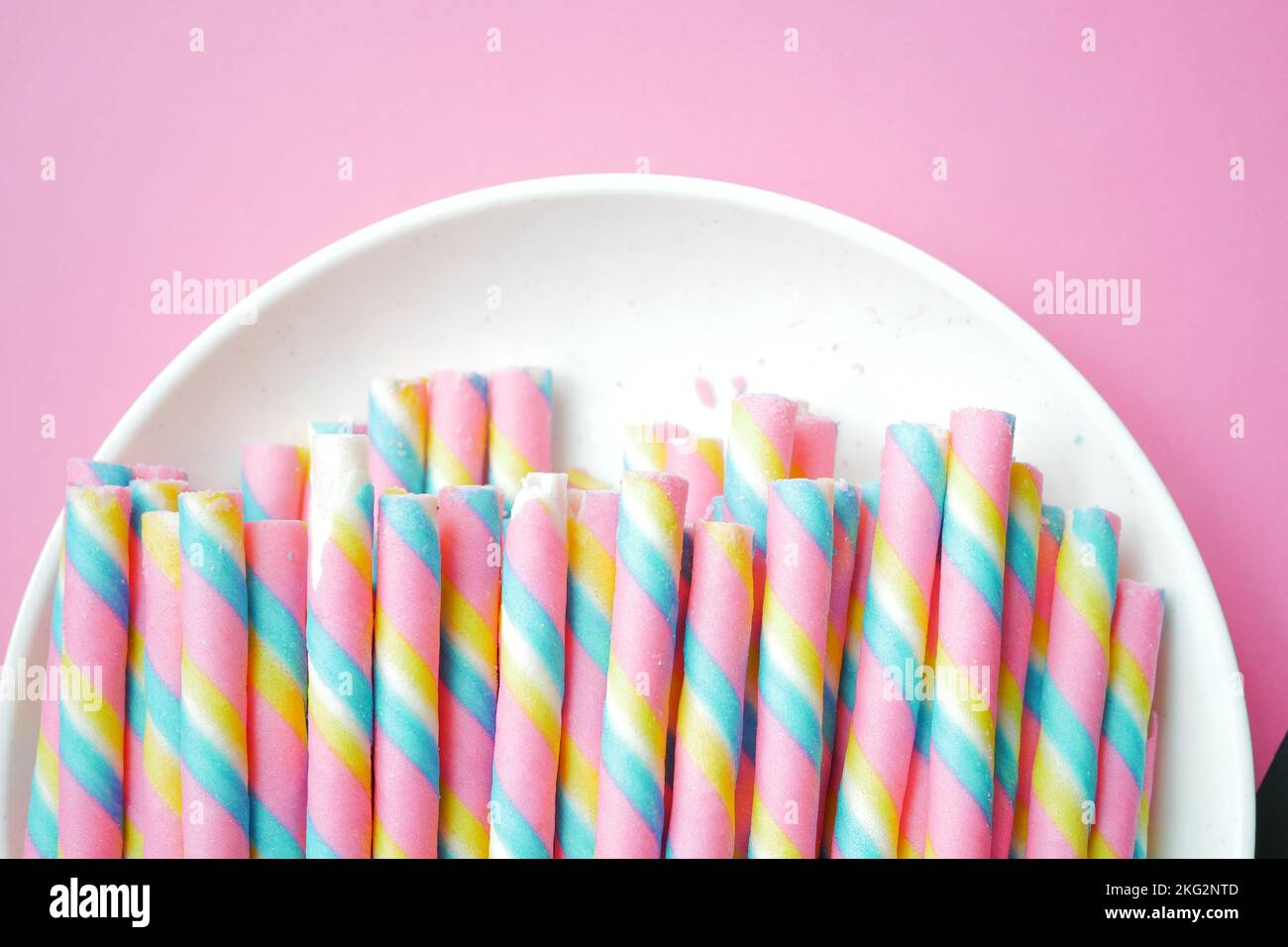colorful wafer roll chocolate on pink background Stock Photo - Alamy