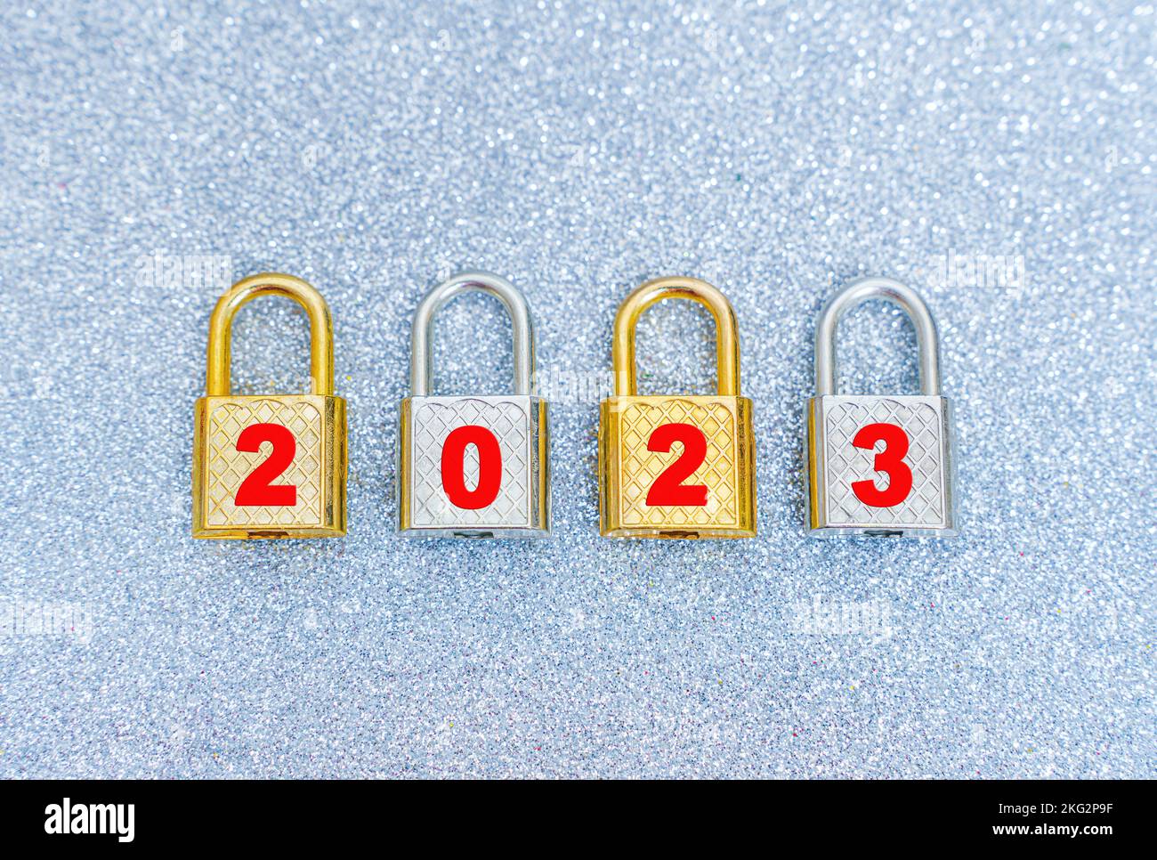 Group of locked steel padlocks reading 2023. The concept of getting ...
