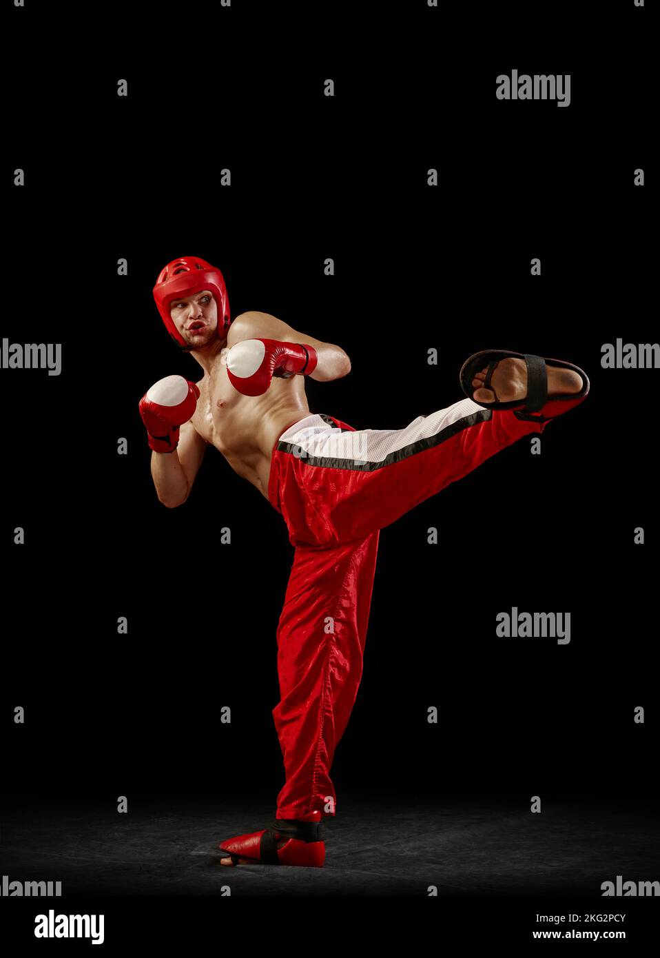 Studio shot of male kickboxer, mma fighter in motion and action ...