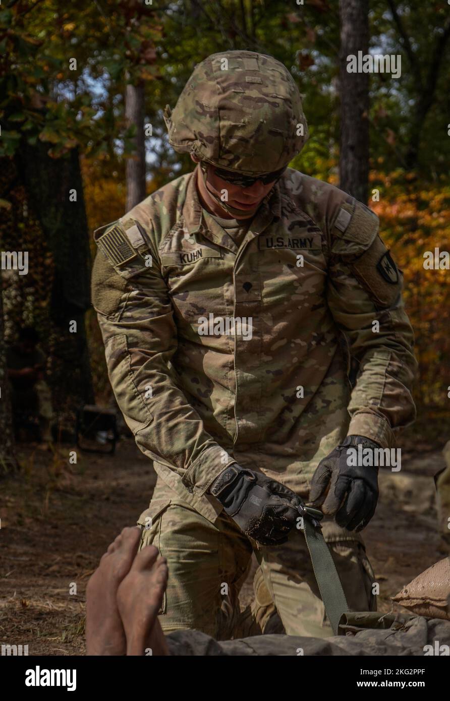 A competitor assigned to the 44th Medical Brigade secures a simulated ...