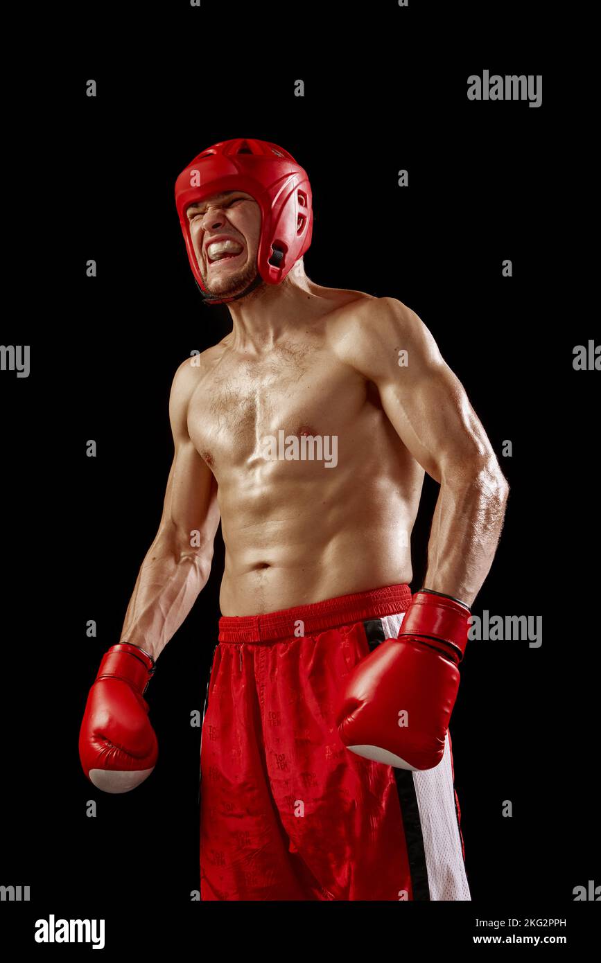 Studio shot of male kickboxer, mma fighter in motion and action ...