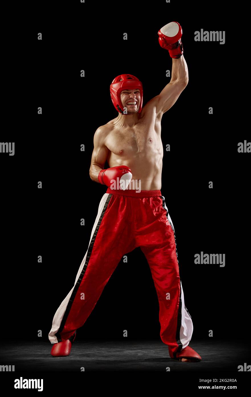 Studio shot of male kickboxer, mma fighter in motion and action ...