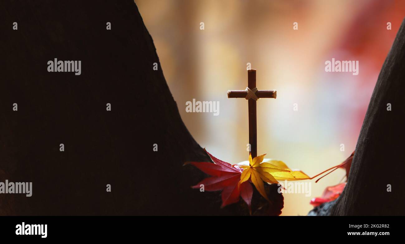 Holy cross of Jesus Christ and bible book among autumn leaves, red ...