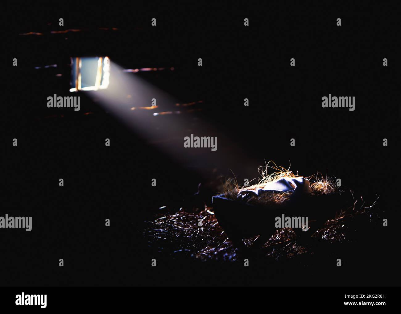 Bright light from the window illuminates the baby Jesus in the manger ...