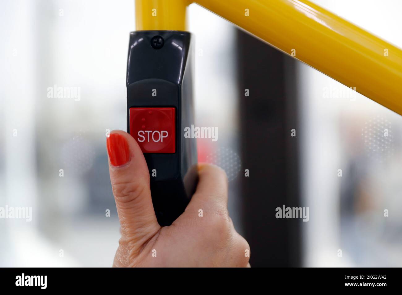 Bus stop button for getting off. Close up on hand. Public ...