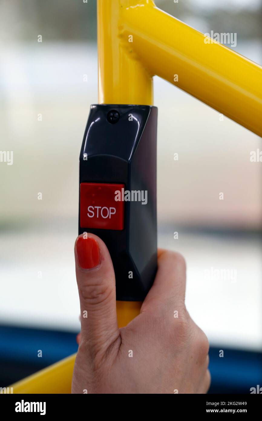 Bus stop button for getting off. Close up on hand. Public ...