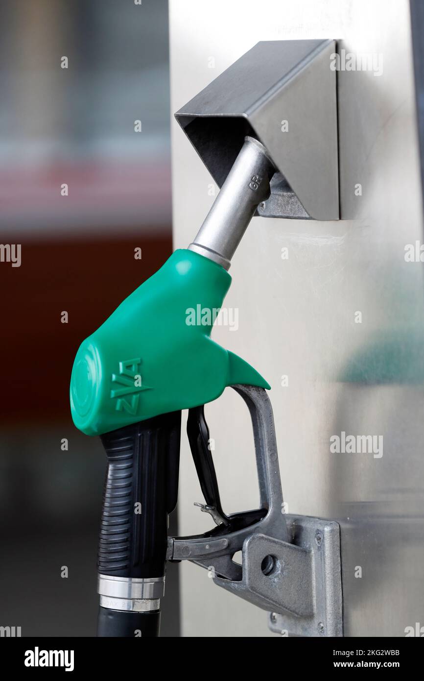 Gasoline and oil products concept. Green fuel pistol on fuel station ...