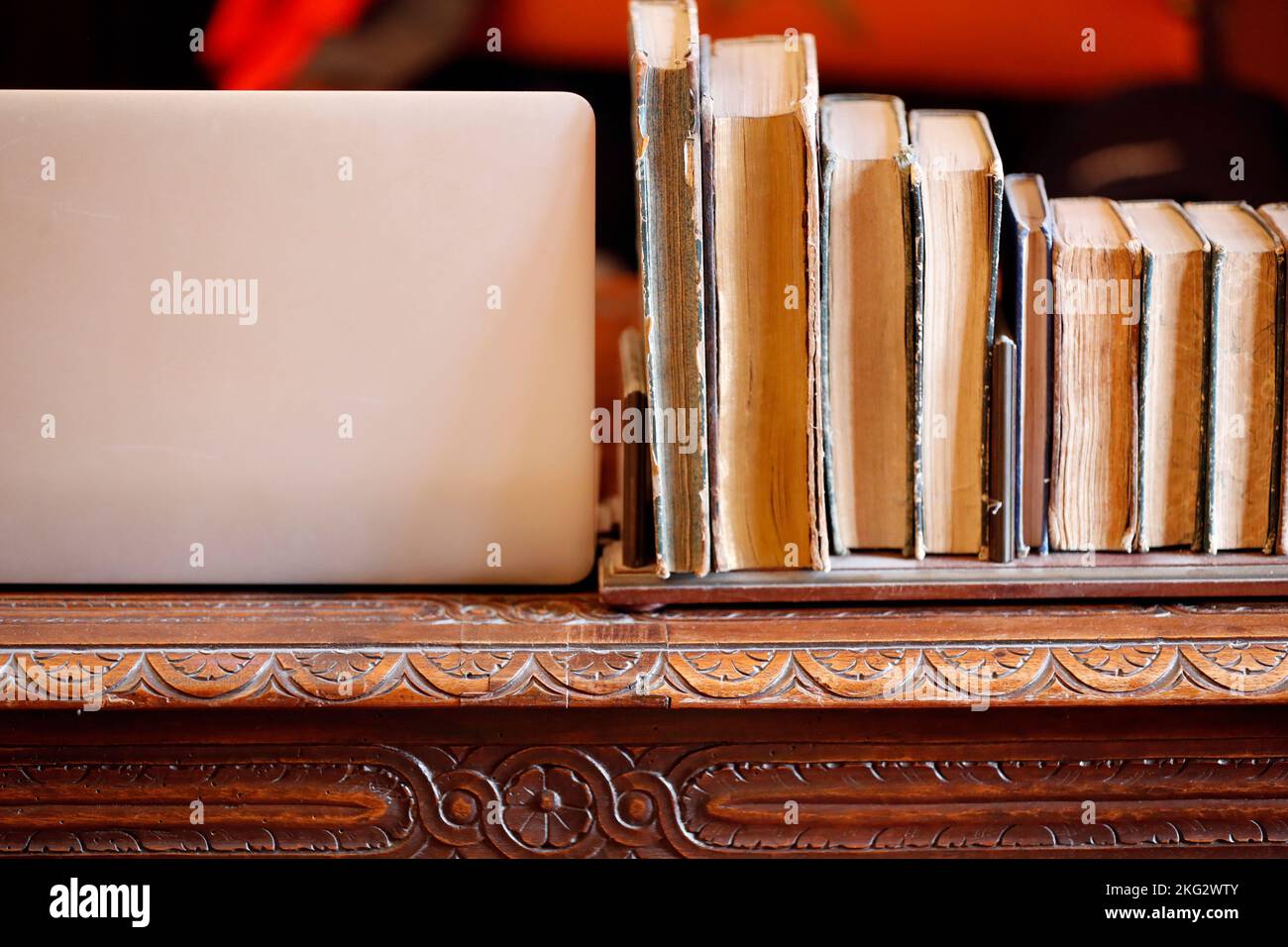 Stack of old books and laptop computer. Home office, homeschooling ...