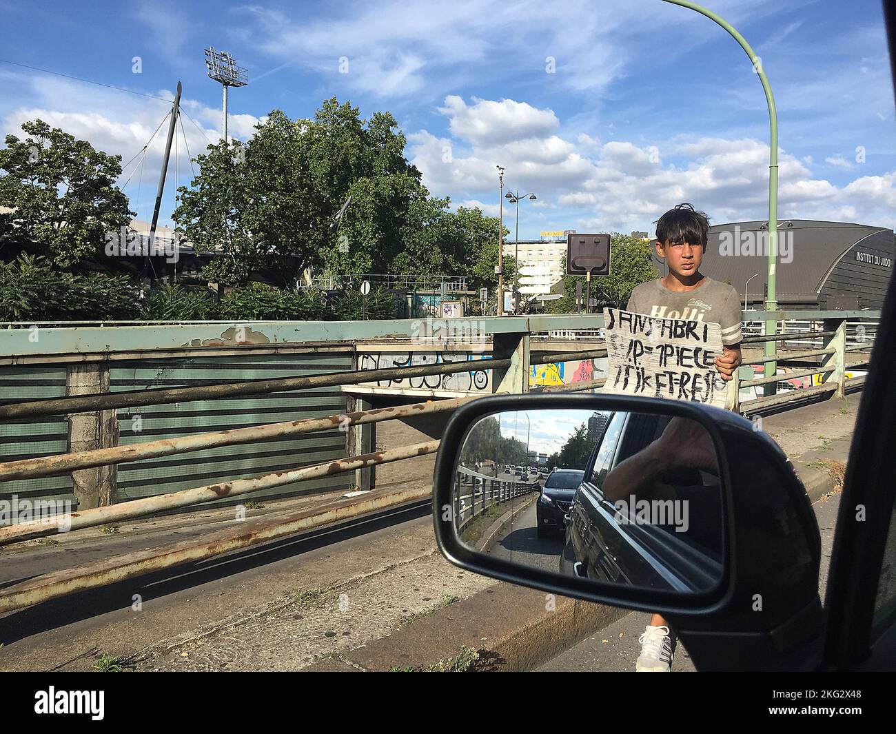 Young migrant begging on the south circular in Paris, France Stock ...