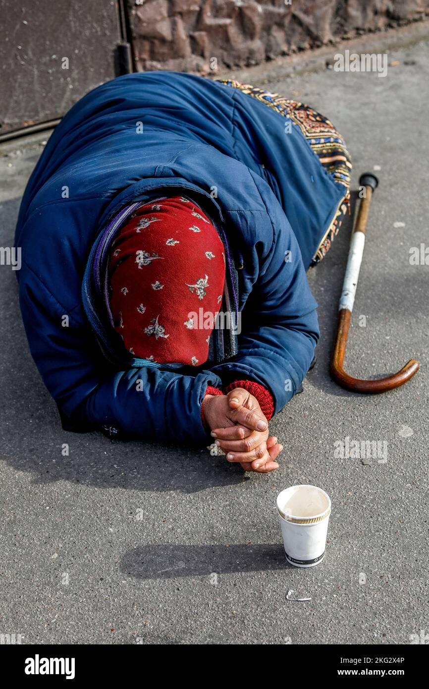 Beggar lying on a sidewalk in Paris, France Stock Photo - Alamy
