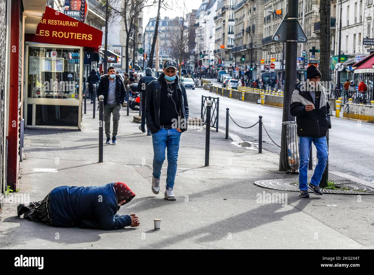 Beggar lying in the street hi-res stock photography and images - Alamy