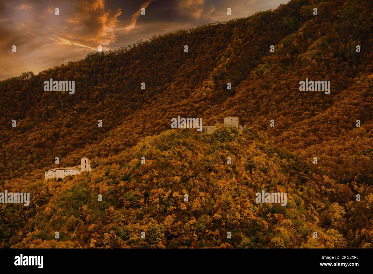 A landscape of buildings on hills covered in forests in autumn in ...