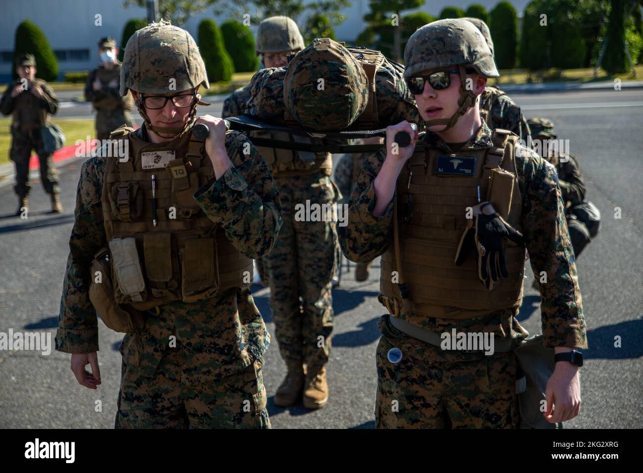 U.S. Navy Hospital Corpsmen with Marine Aircraft Group (MAG) 12 carry a ...